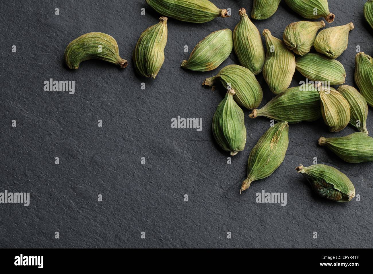 Dry cardamom pods on black table, top view. Space for text Stock Photo ...