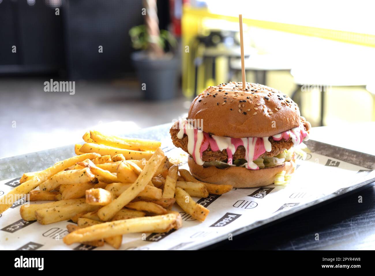 A vegan chicken style burger with fries, from V-face restaurant in ...
