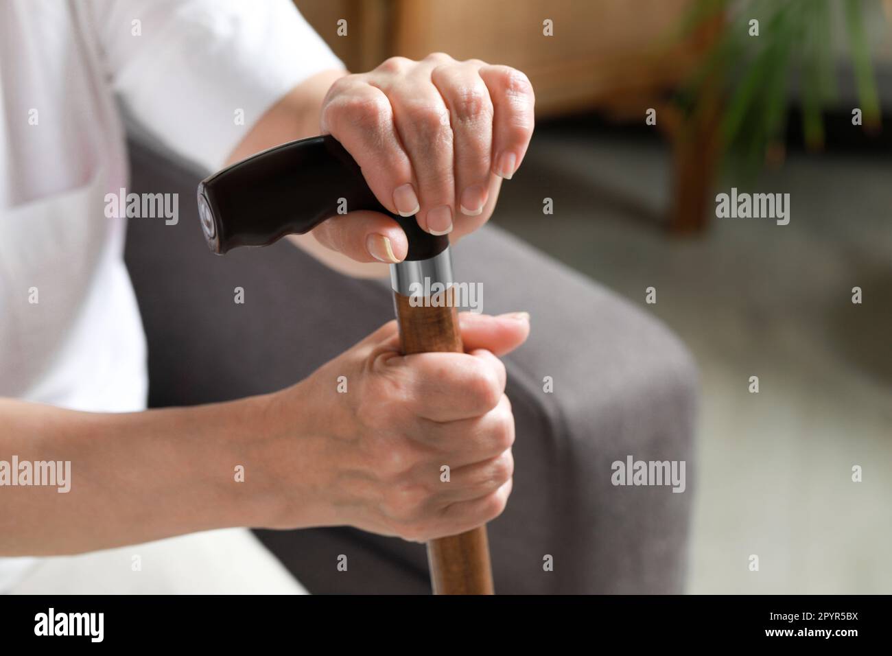 Elderly woman with walking cane indoors, closeup. Home care service ...