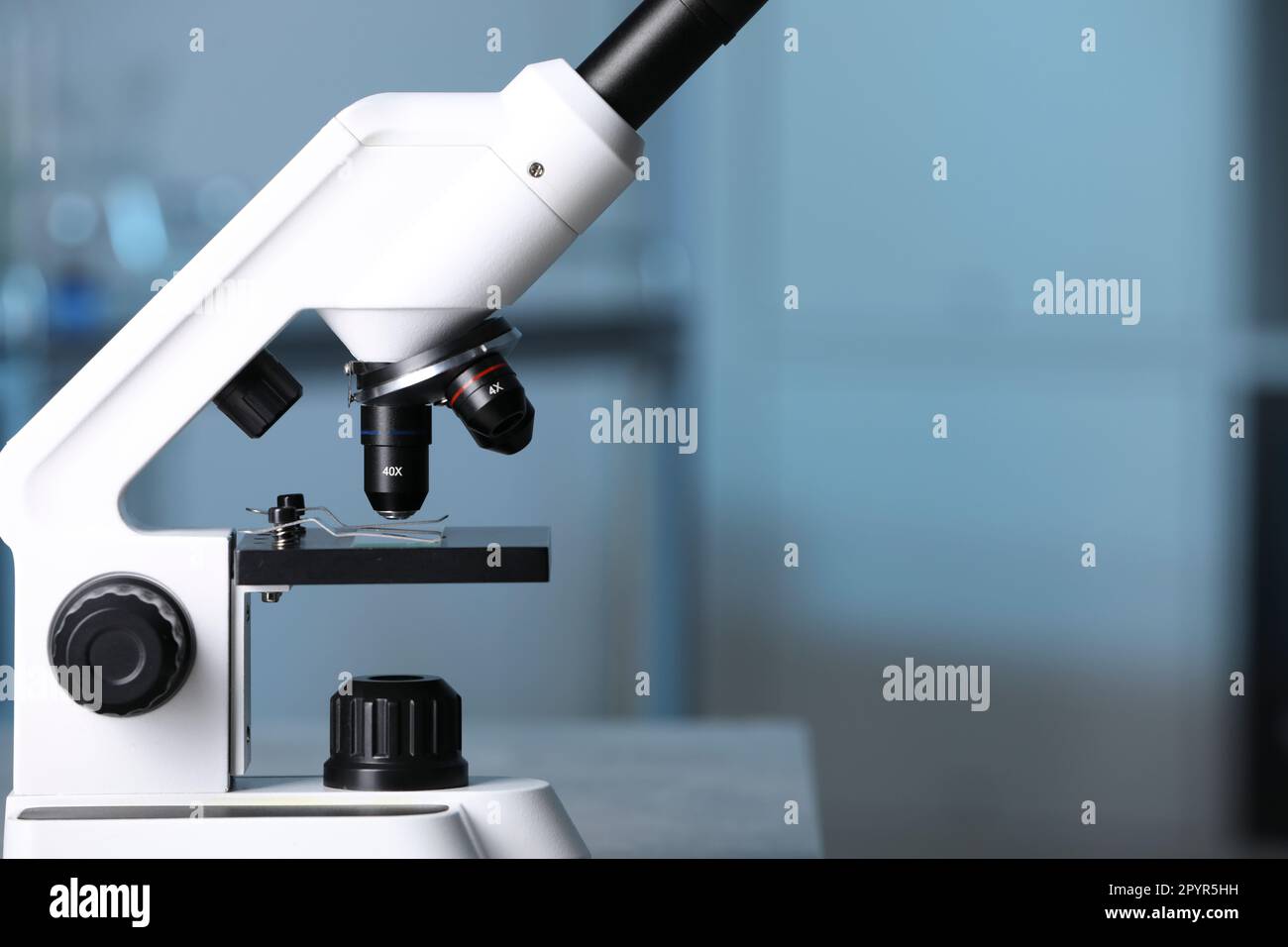 Modern medical microscope against blurred background, closeup. Space ...