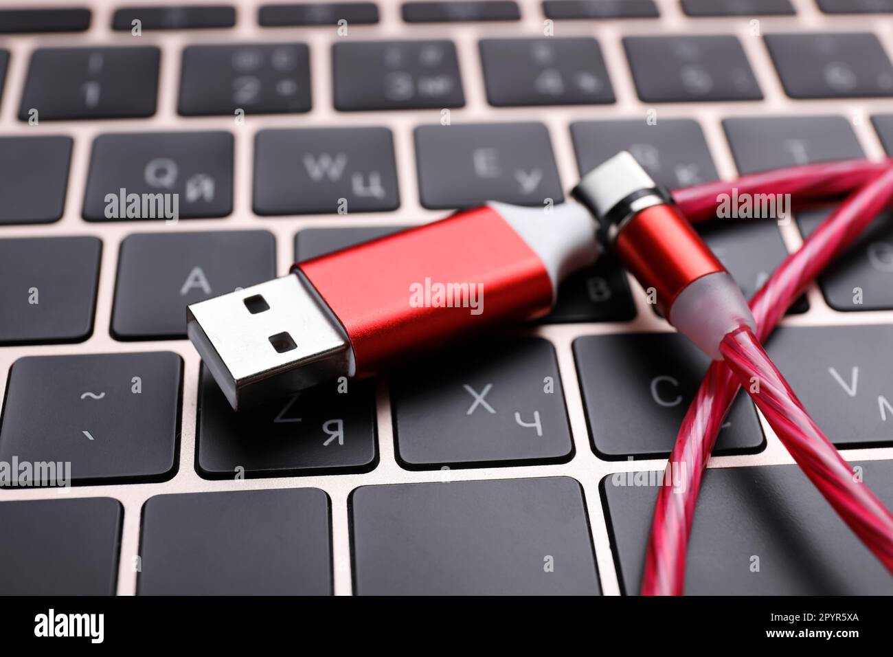 USB cable with type C connector on laptop keyboard, closeup Stock Photo ...