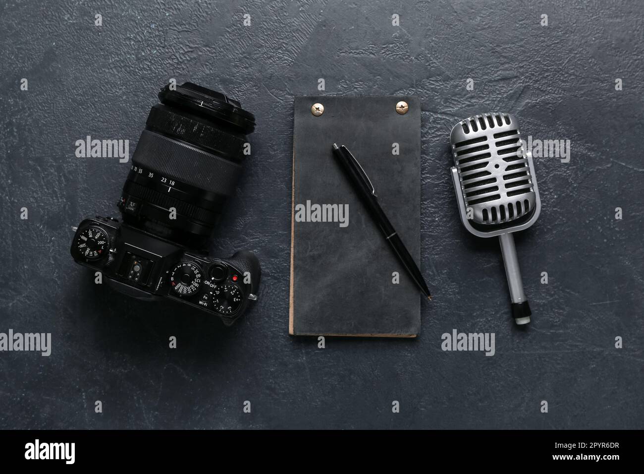 Notebook with photo camera and microphone on dark background Stock ...