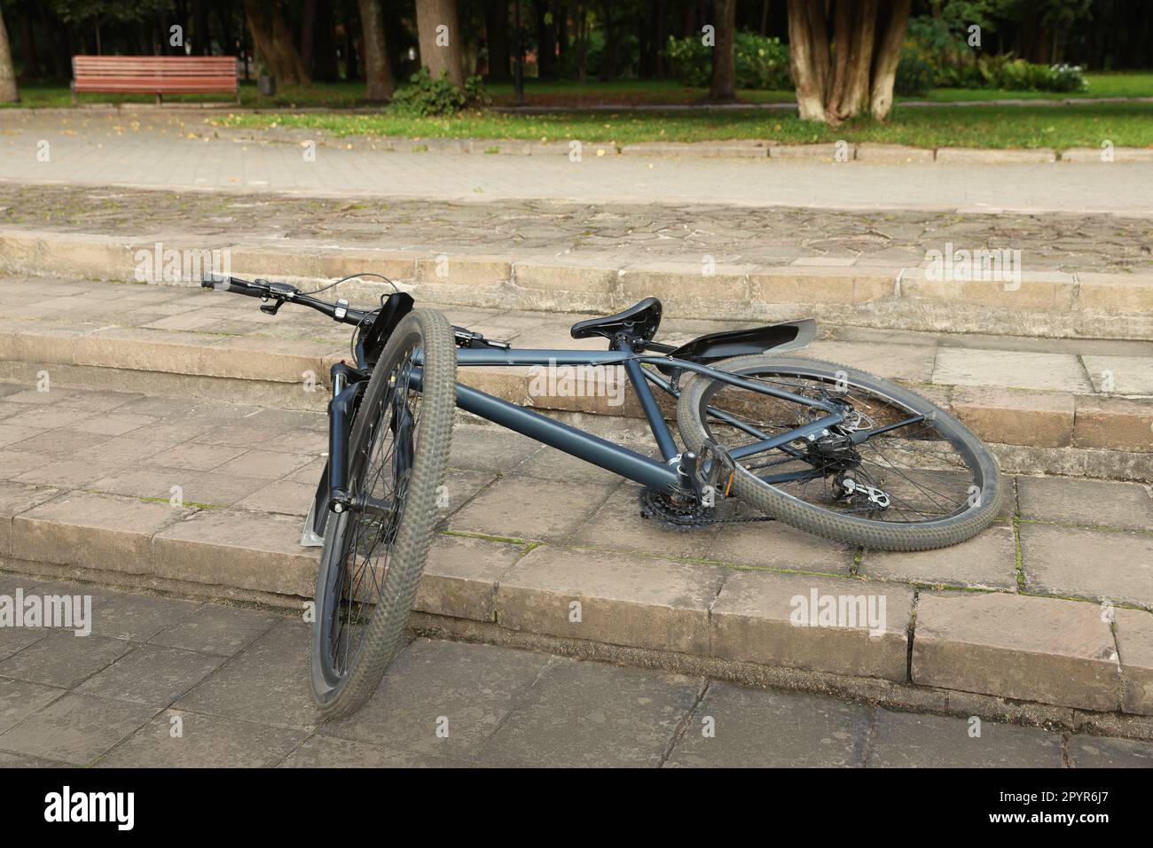 Fallen beautiful modern bicycle on steps outdoors Stock Photo - Alamy