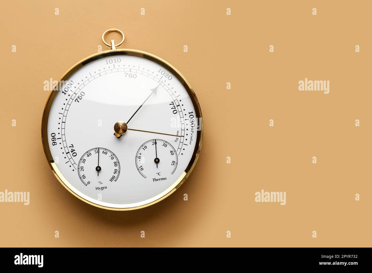Aneroid barometer on brown background Stock Photo - Alamy