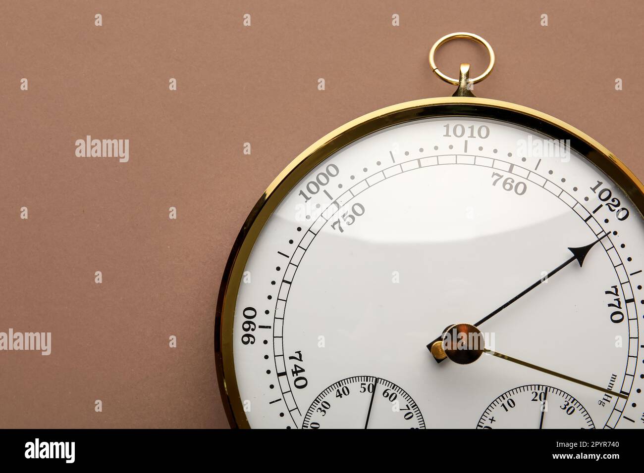 Aneroid barometer on brown background Stock Photo - Alamy