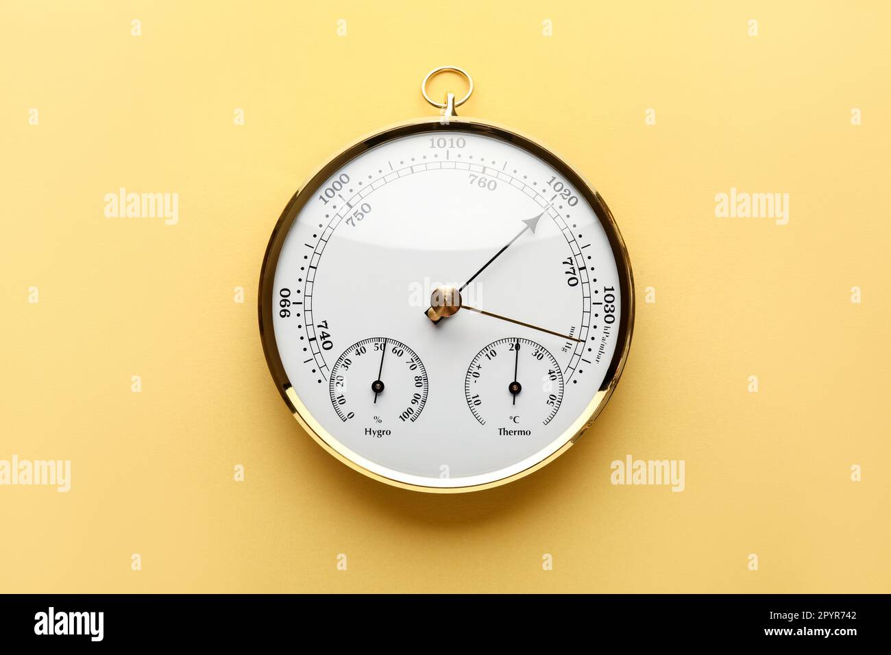 Aneroid barometer on yellow background Stock Photo - Alamy