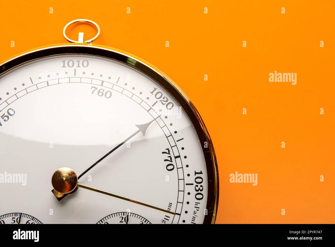 Aneroid barometer on orange background Stock Photo - Alamy