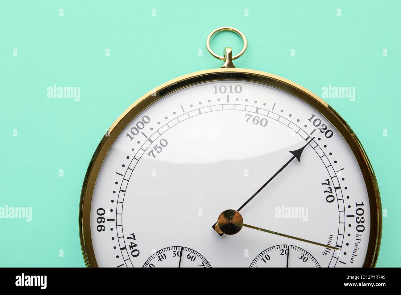 Aneroid barometer on turquoise background Stock Photo - Alamy