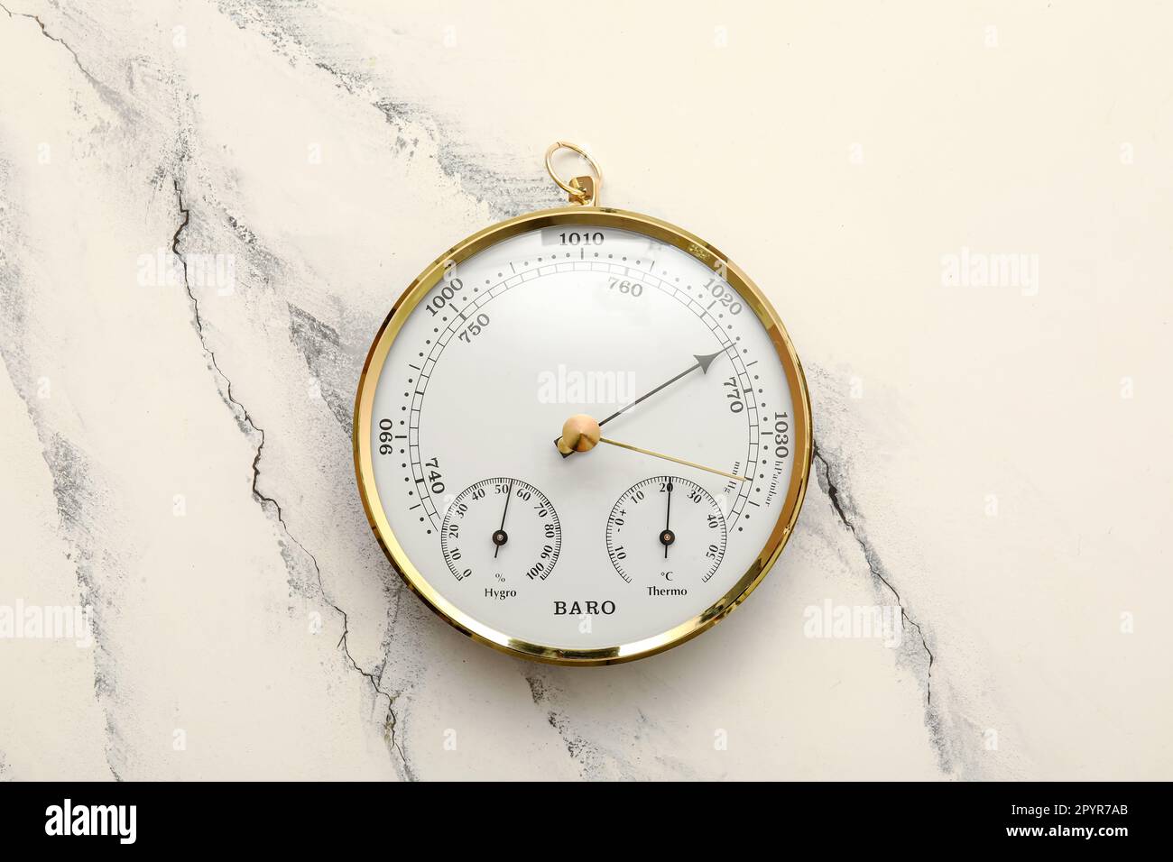 Aneroid barometer on white marble background Stock Photo - Alamy