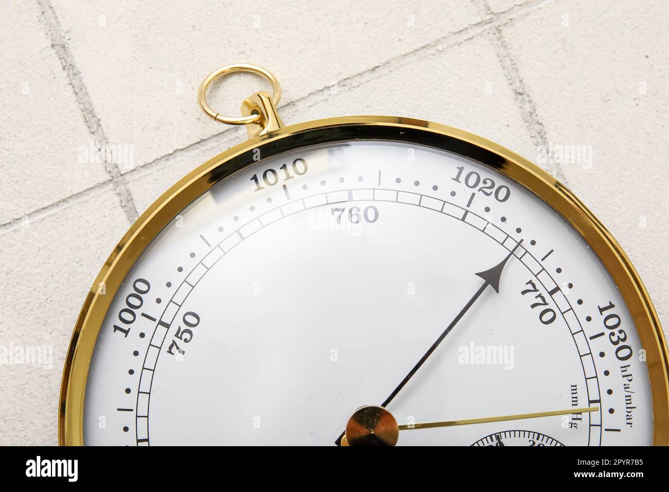 Aneroid barometer on white tiled background Stock Photo - Alamy
