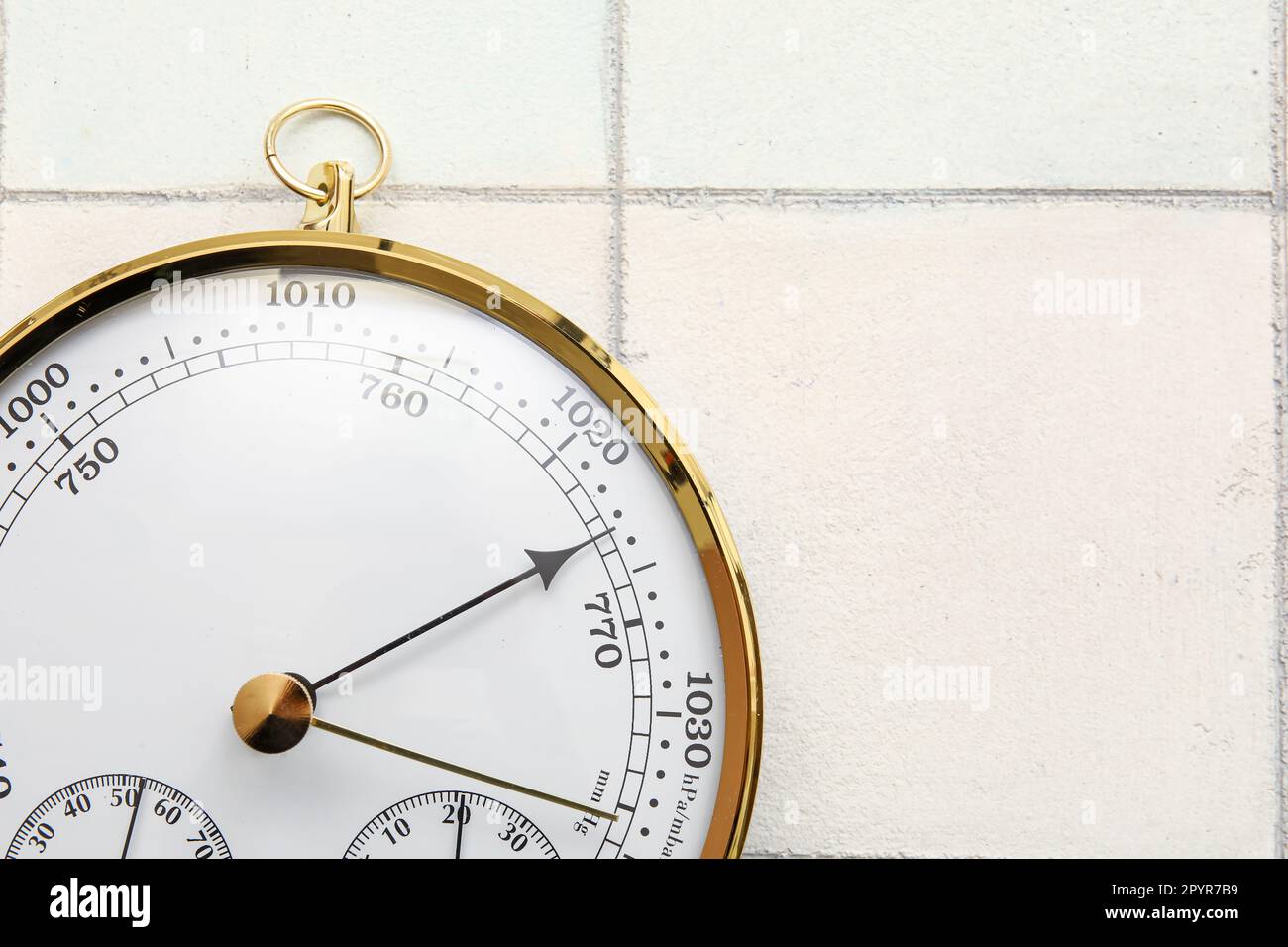 Aneroid barometer on white tiled background Stock Photo - Alamy