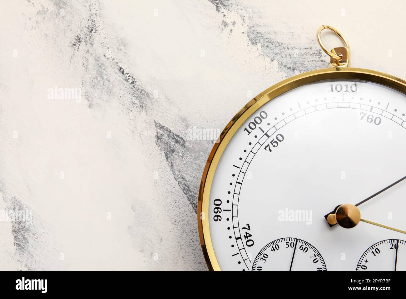 Aneroid barometer on white marble background Stock Photo - Alamy