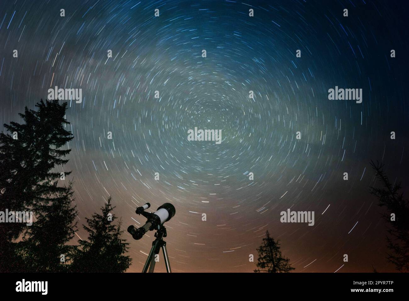Modern telescope under night sky with star trails outdoors, low angle ...