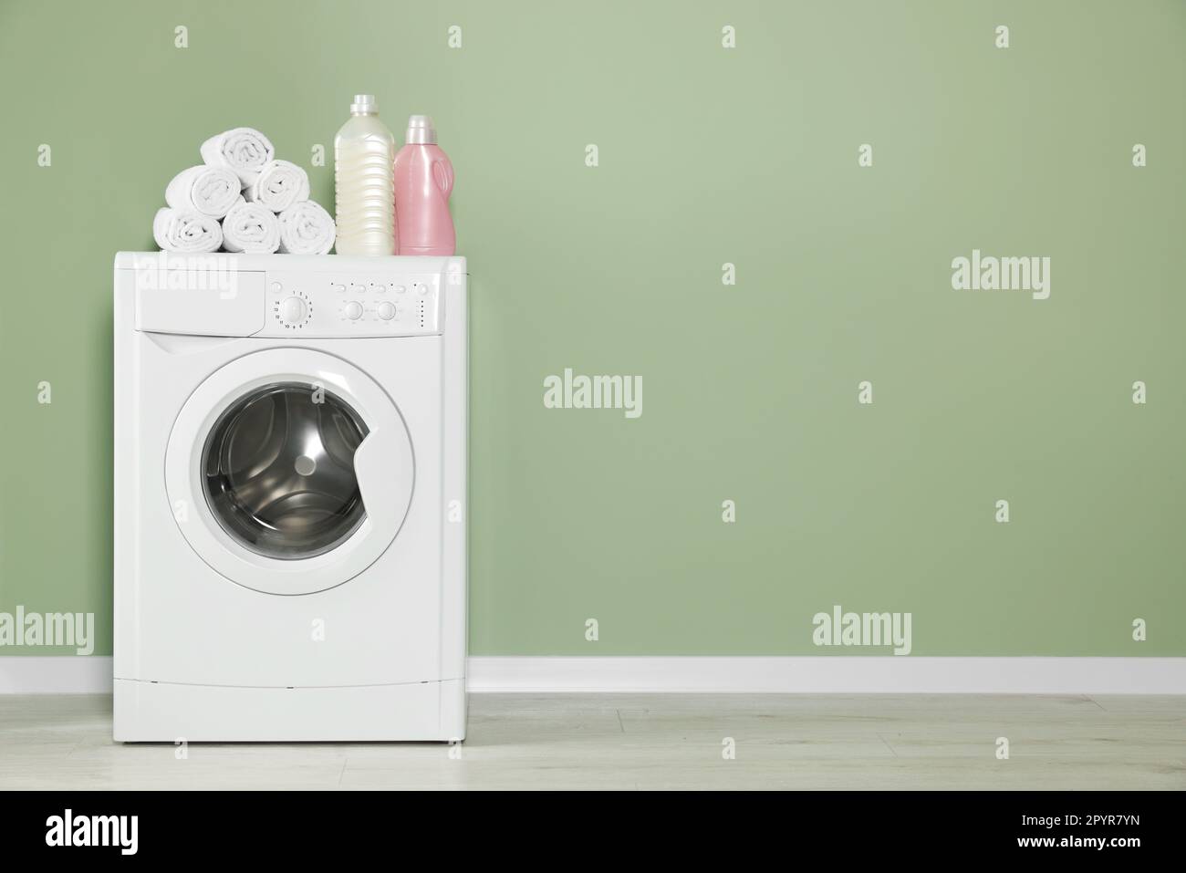 Empty laundry room with washing machine and detergents, space for text ...