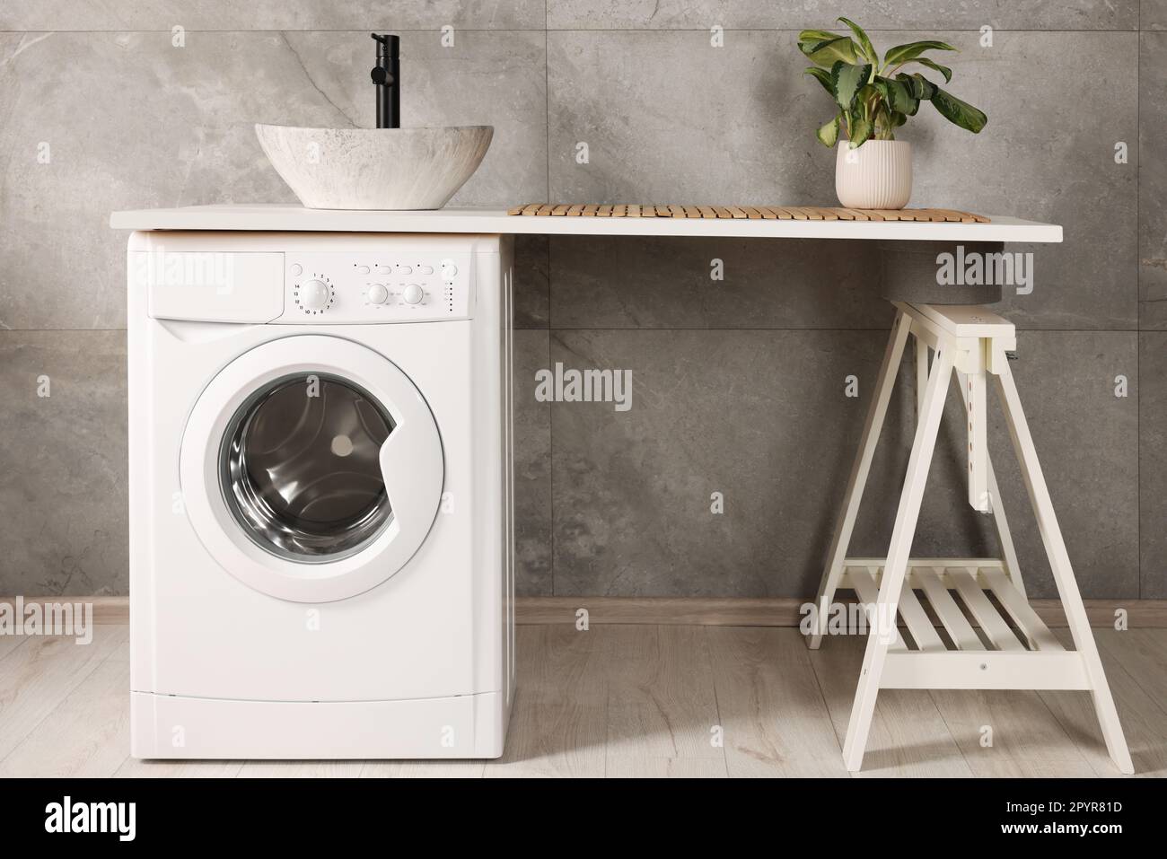 Stylish laundry room with modern washing machine. Interior design Stock ...