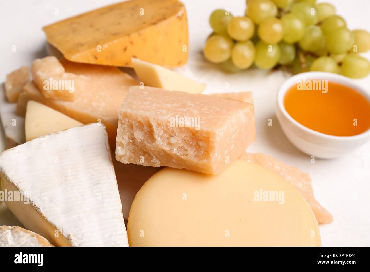 Different types of tasty cheese on light background, closeup Stock ...