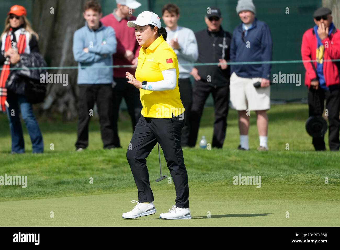 China's Ruixin Liu waves after making a putt on the 11th hole at the ...