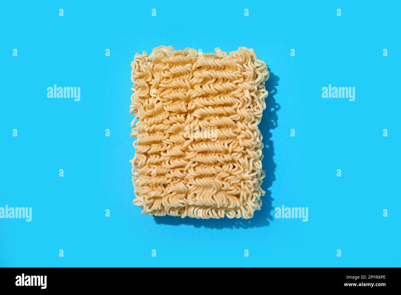 Raw instant noodles on blue background Stock Photo - Alamy