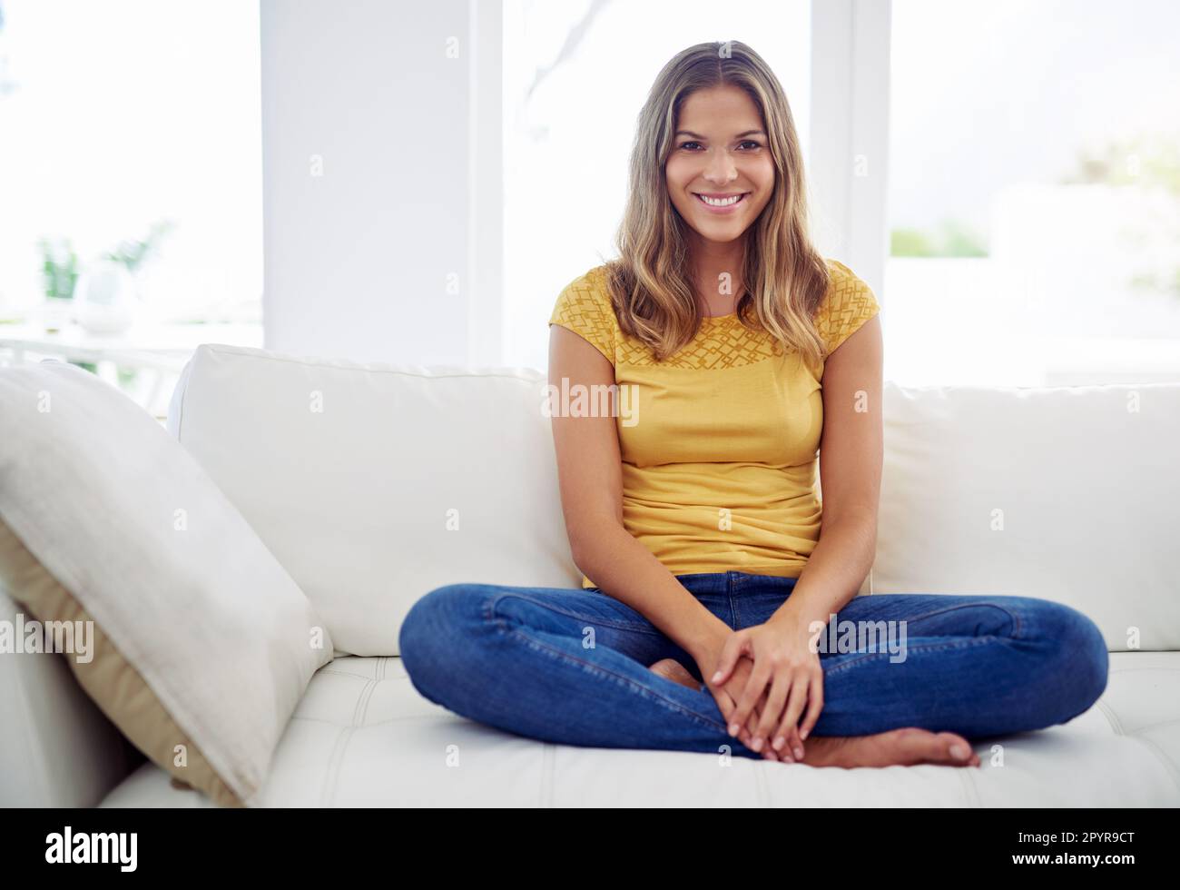 Weekends are for the sofa. Full length portrait of an attractive young woman sitting with her ...