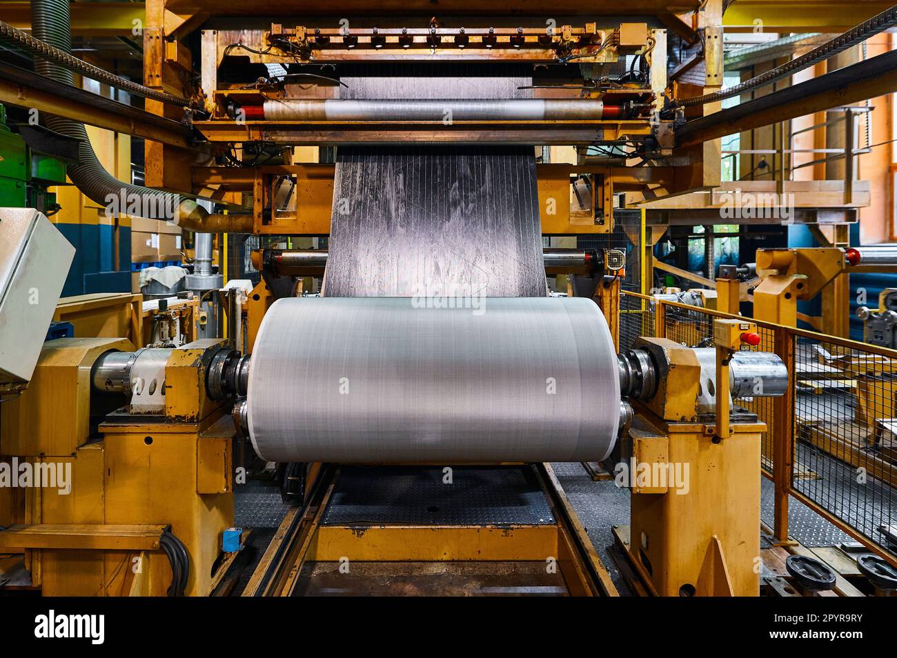 Rolling reinforced sheet on reel drum with rubber band Stock Photo - Alamy