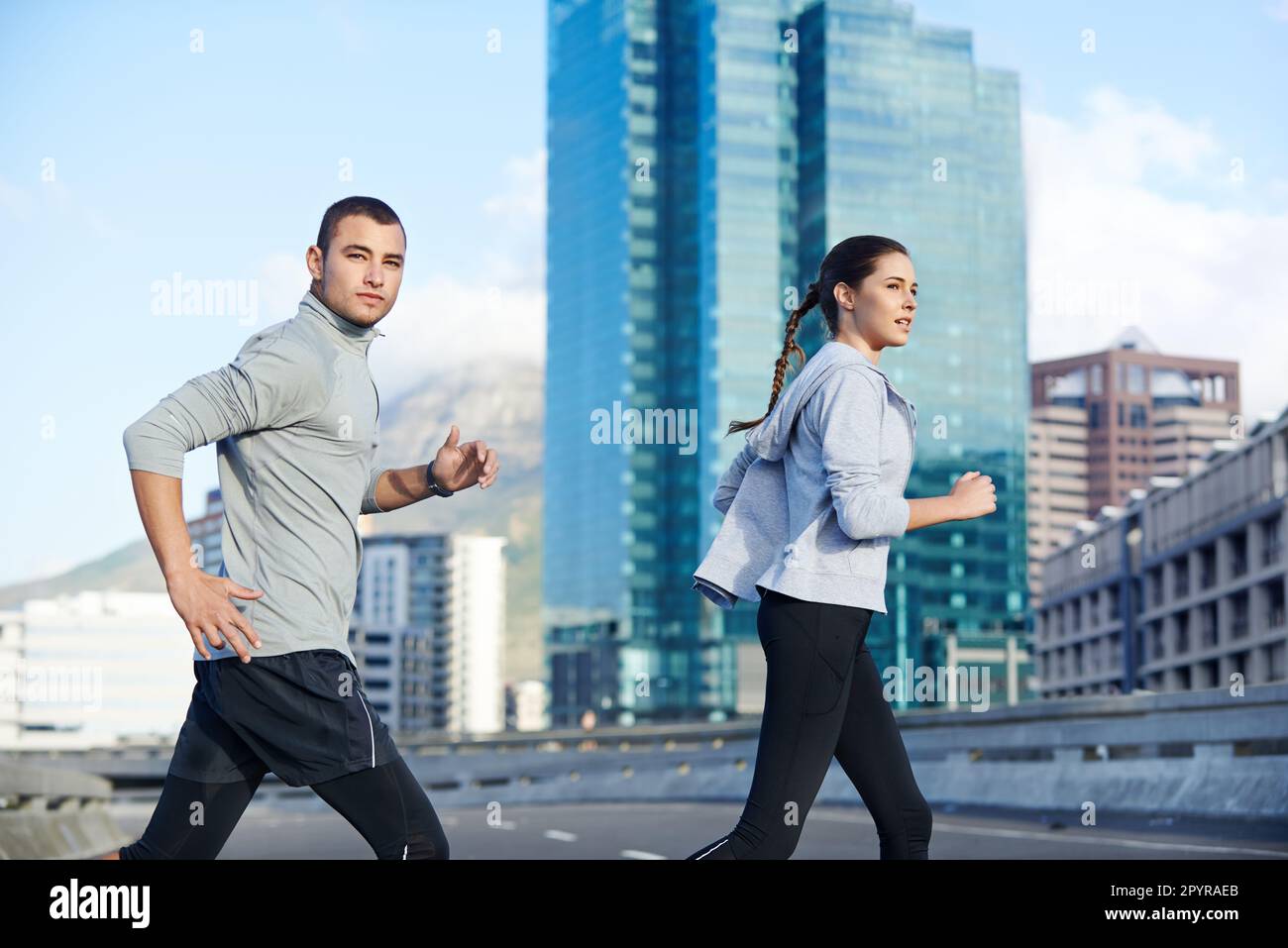 Still going strong after miles. two friends jogging together through ...