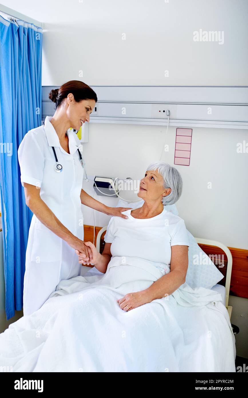 Taking a moment to calm her fears. a beautiful young doctor comforting ...