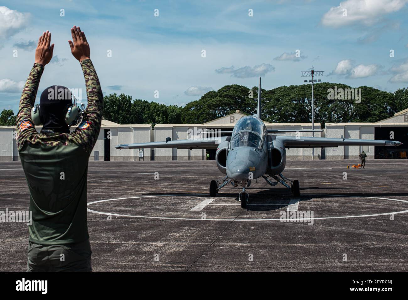 A Philippine Air Force member marshals a FA-50PH before a flight during ...