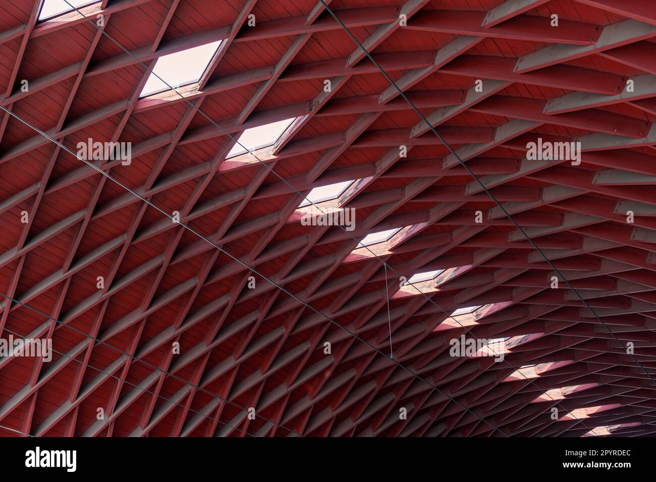 Low angle view at modern red arch ceiling with harlequin pattern of ...