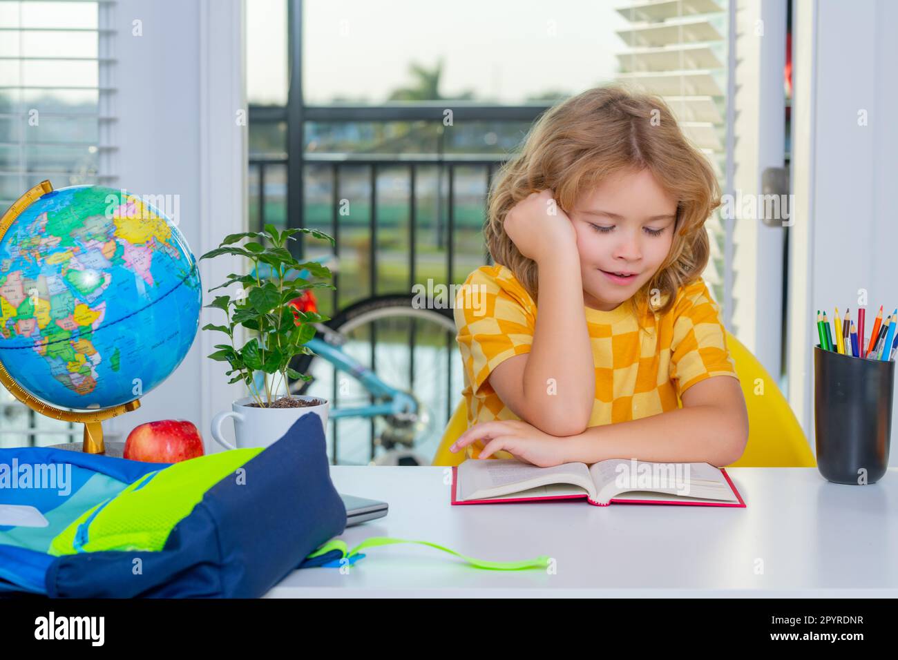 Child reading book. School kids at home. Child from elementary school ...