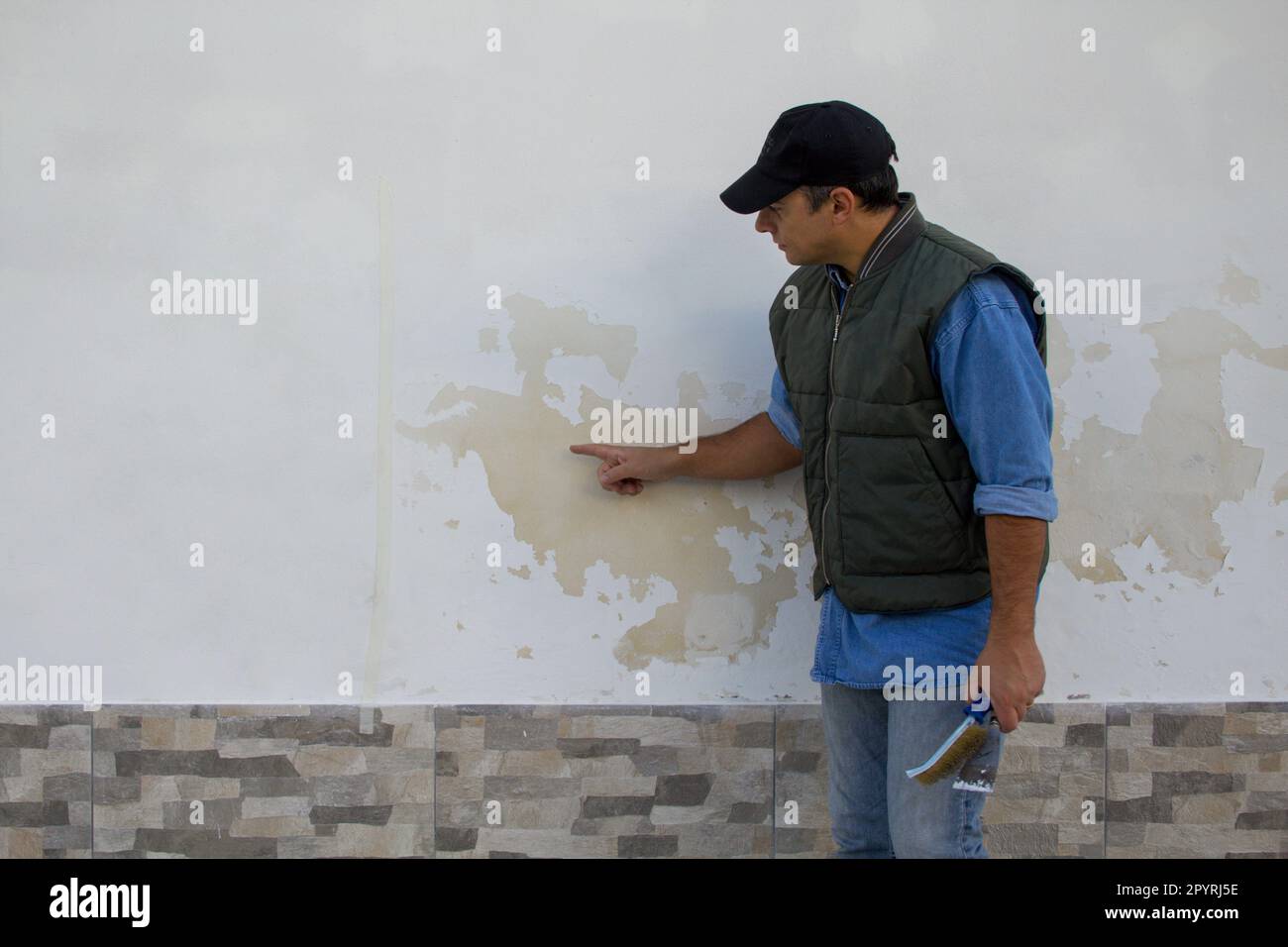 Image of a construction engineer illustrating damage to a brick wall ...