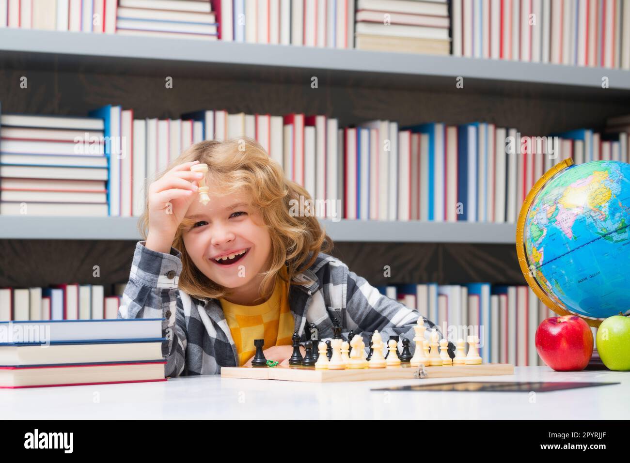 Chess, success and winning. Happy child playing chess. Child boy ...