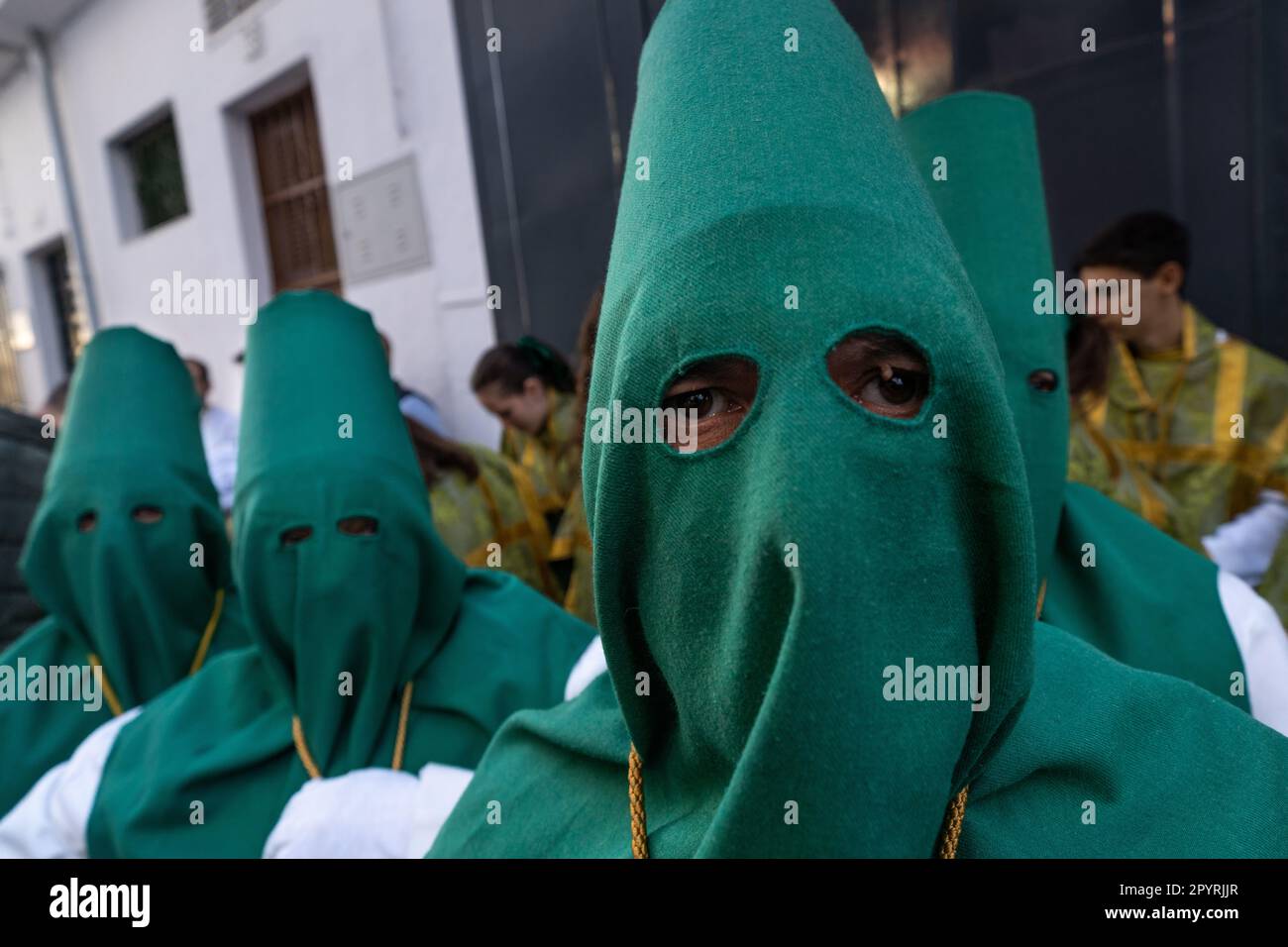 Cofradias wearing green hoods line up before a procession during Holy ...