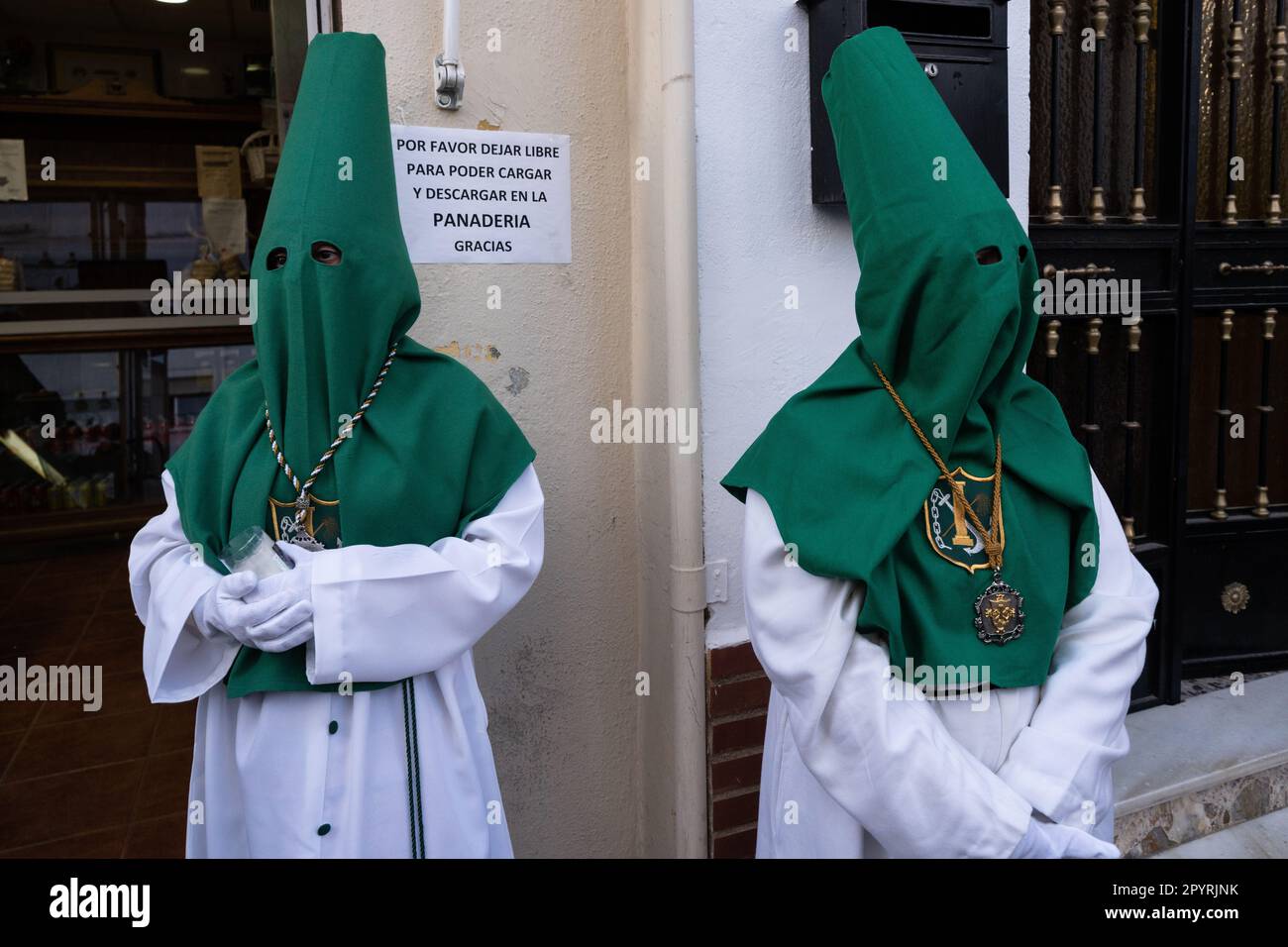 Cofradias wearing green hoods line up before a procession during Holy ...