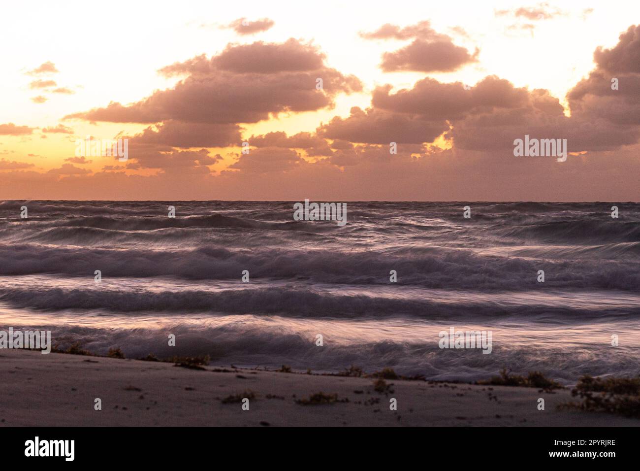 The tide is pulling in the waves while the sun is bringing on a new day ...