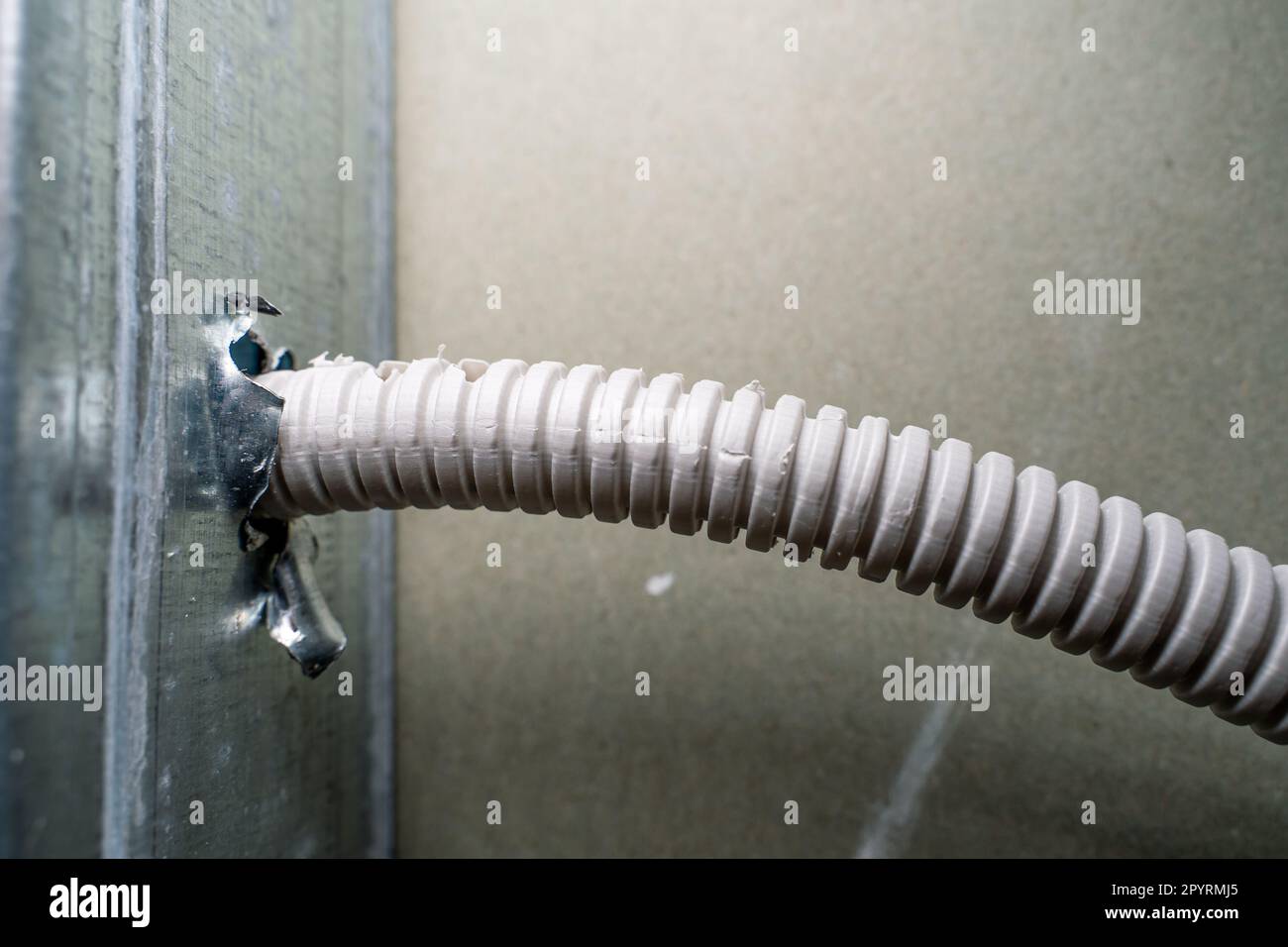 The wires in the protective corrugated pipe are led through the hole ...