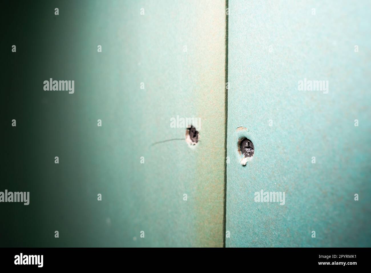 Joint of sheets of drywall close-up. Fastening drywall with black ...