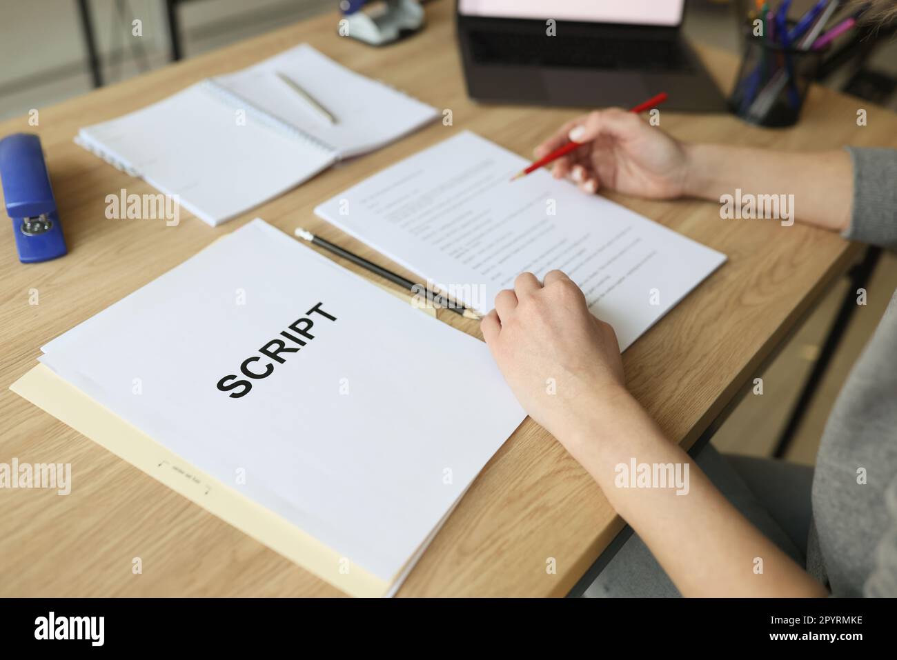 Actress checks script papers making notes with pencil Stock Photo - Alamy