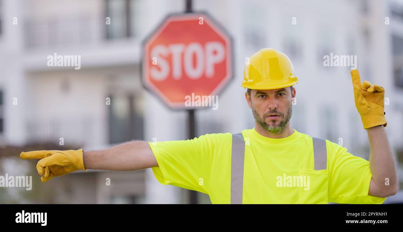 Builder with stop road sign. Builder with stop gesture, no hand ...