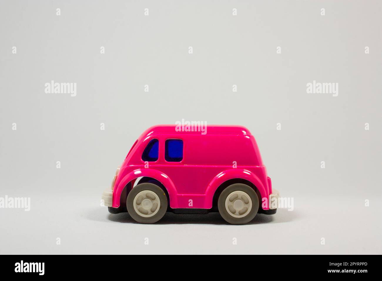 die cast models pink color on white background Stock Photo - Alamy