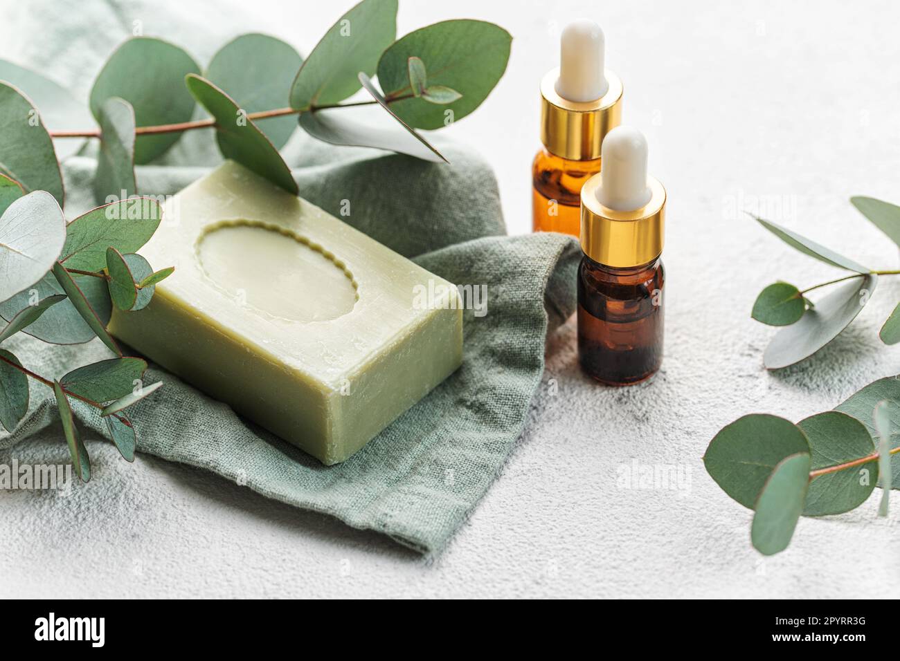 Soap, eucalyptus, aroma oils, spa objects on a concrete background ...