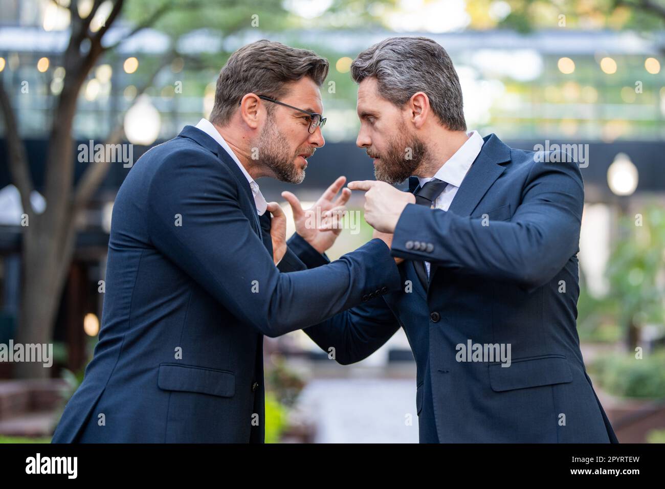 Business men aggressive fight outdoor. Conflict and fight business ...