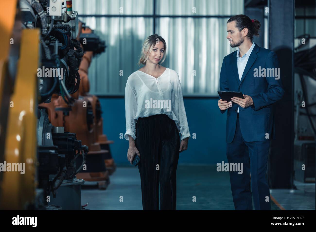 Robotic factory owner explain, discuss functionality and performance of robot systems with ...