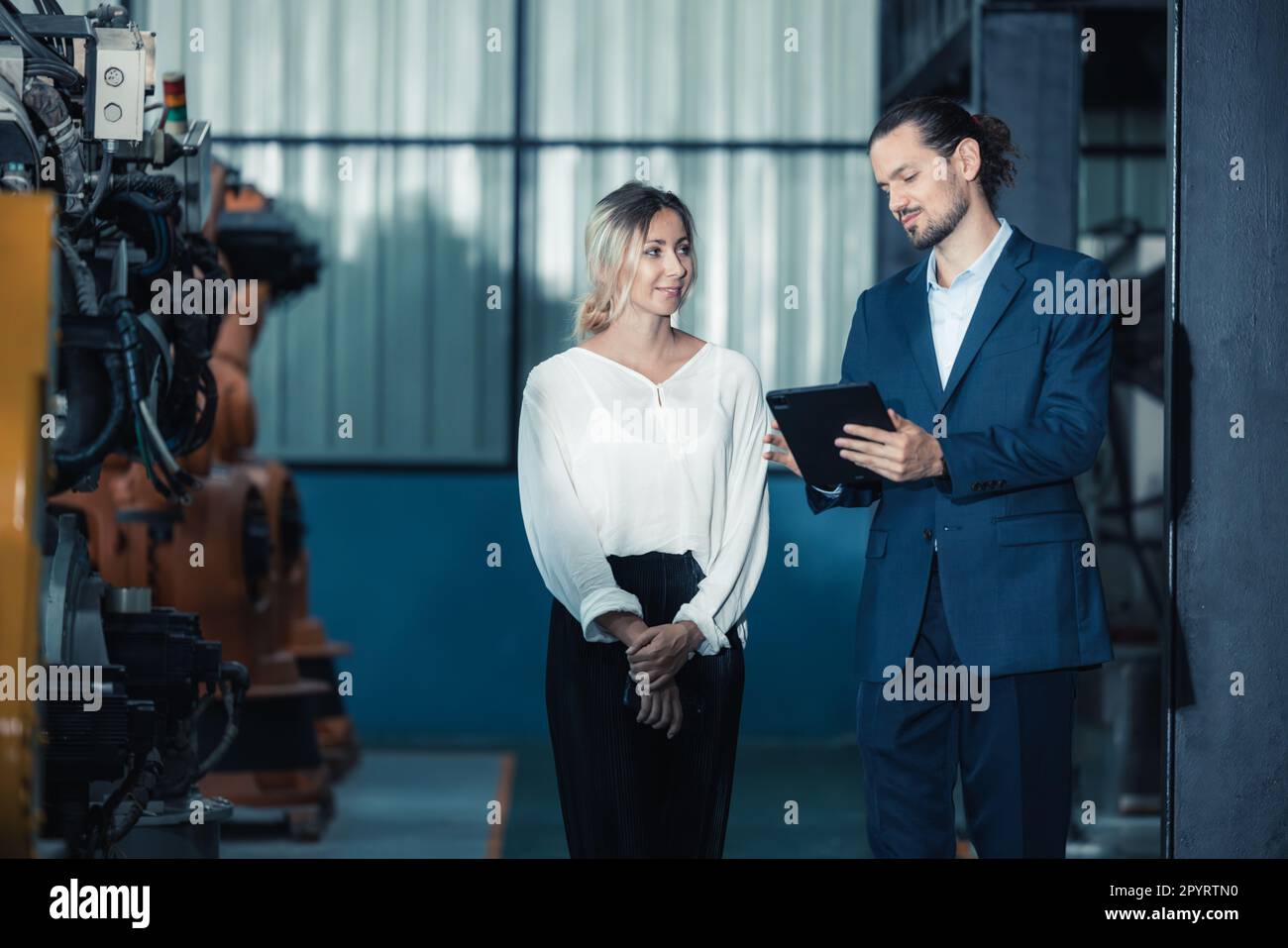 Robotic factory owner explain, discuss functionality and performance of robot systems with ...