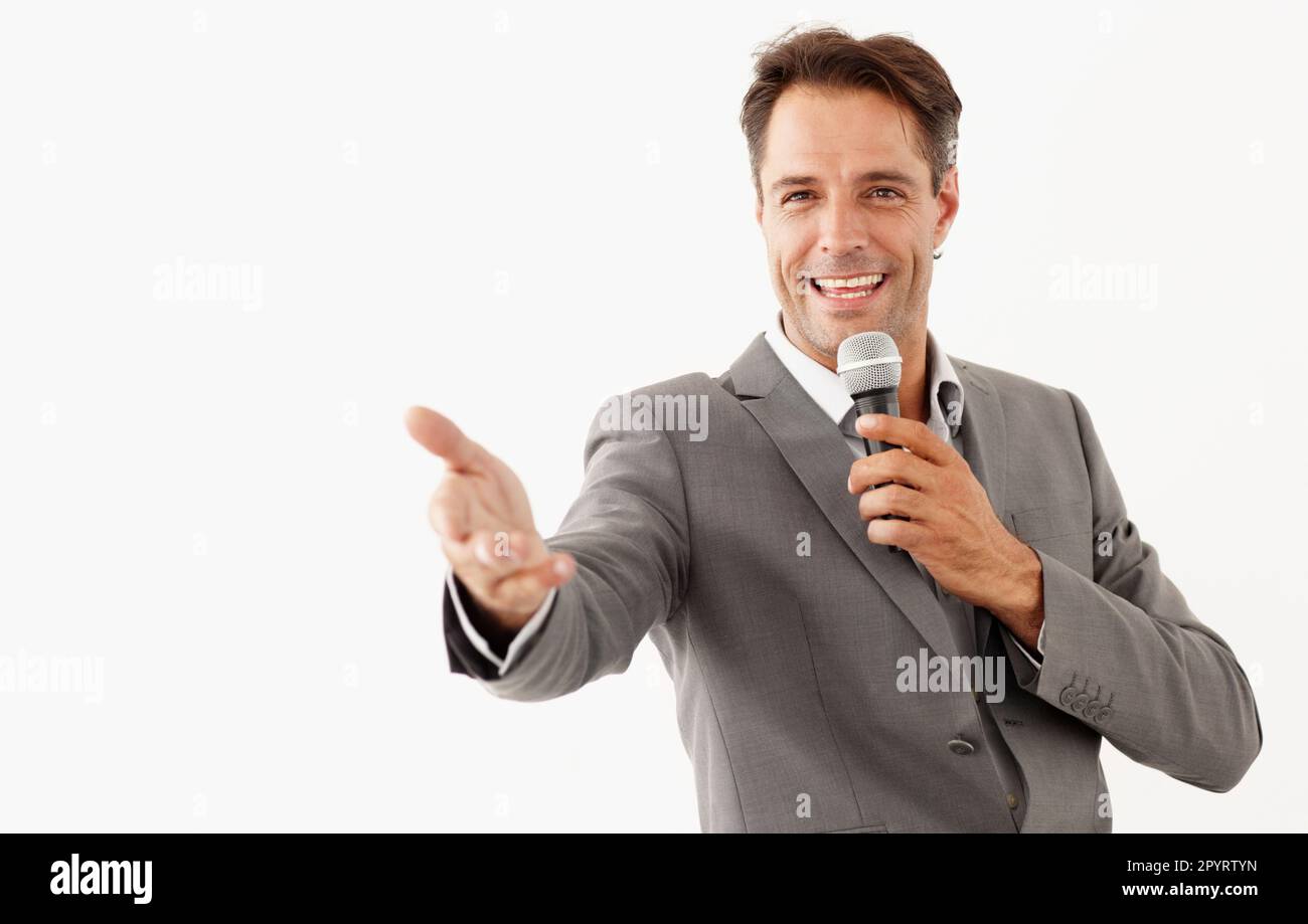 Portrait, microphone and a man motivational speaker in studio isolated ...