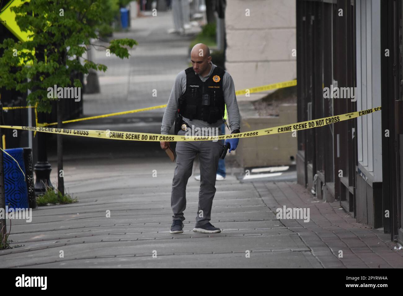 Police officers look for evidence at the crime scene. Bullet fragments ...