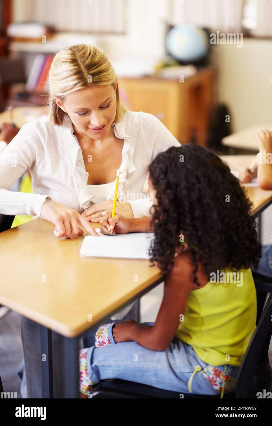 Teaching, writing and teacher helping child at school with education ...