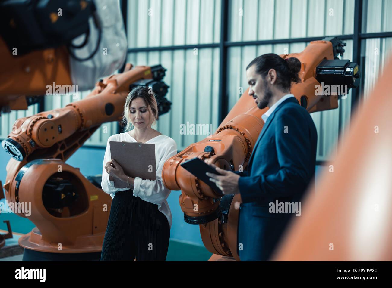 Robotic factory owner explain, discuss functionality and performance of robot systems with ...