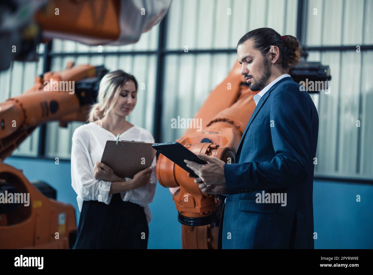 Robotic factory owner explain, discuss functionality and performance of robot systems with ...