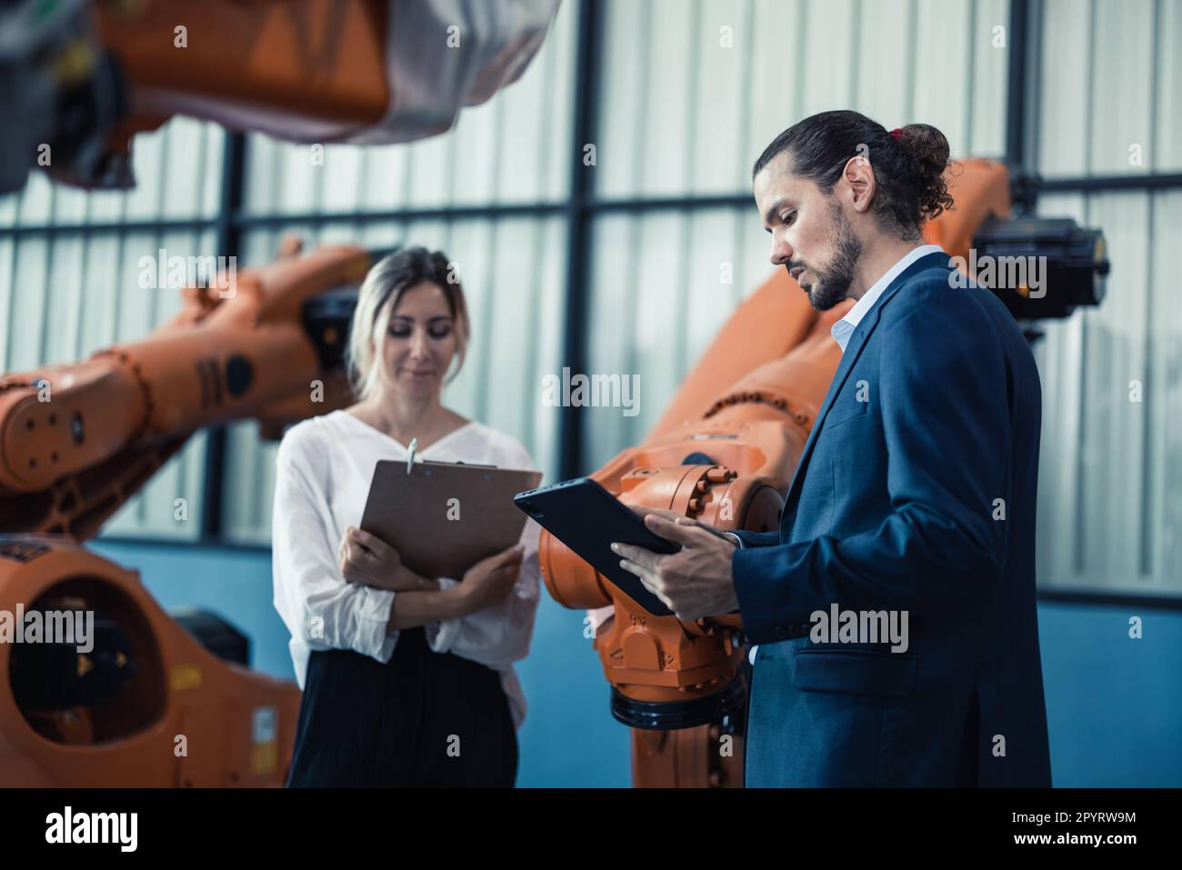 Robotic factory owner explain, discuss functionality and performance of robot systems with ...