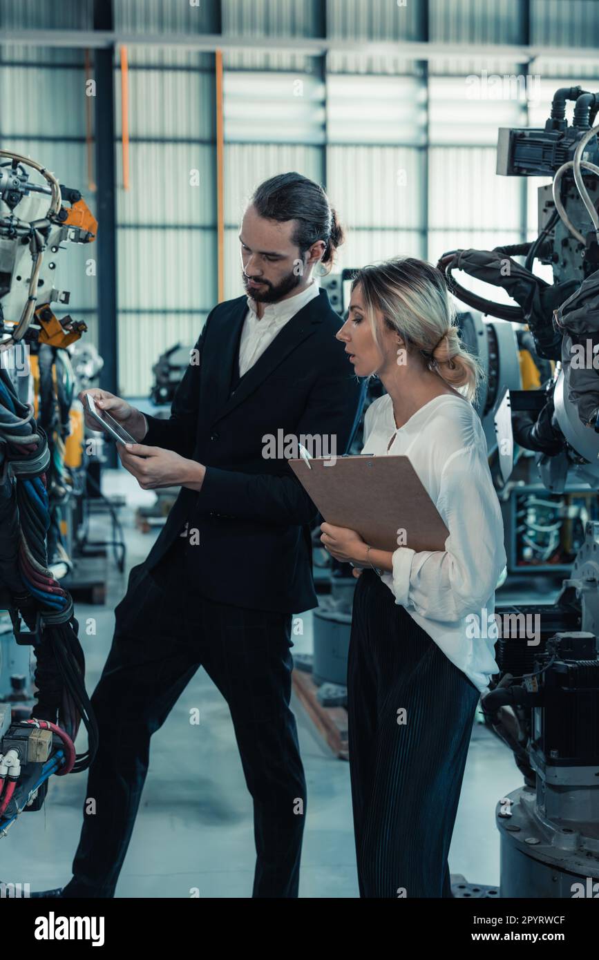 Robotic factory owner explain, discuss functionality and performance of robot systems with ...